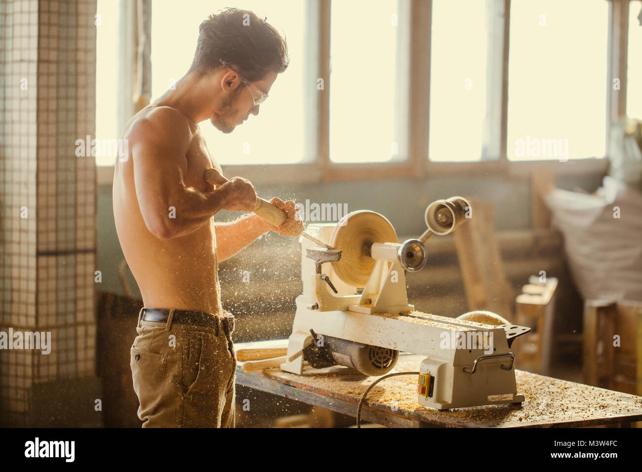 Wood lathe. Carpenter lathing wood Stock Photo - Alamy