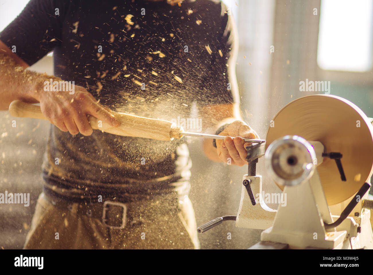 Wood lathe. Carpenter lathing wood Stock Photo - Alamy