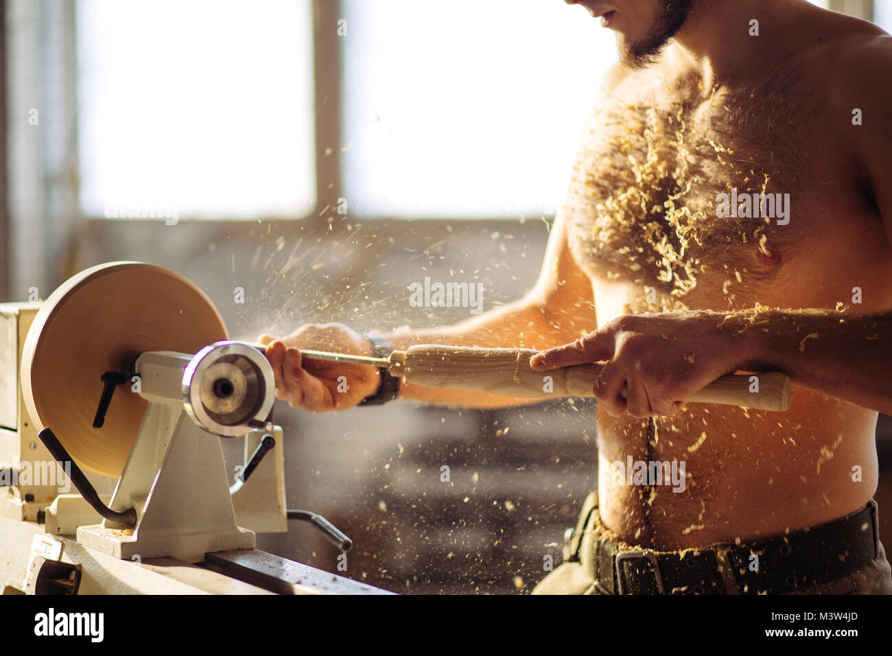 Wood lathe. Carpenter lathing wood Stock Photo - Alamy