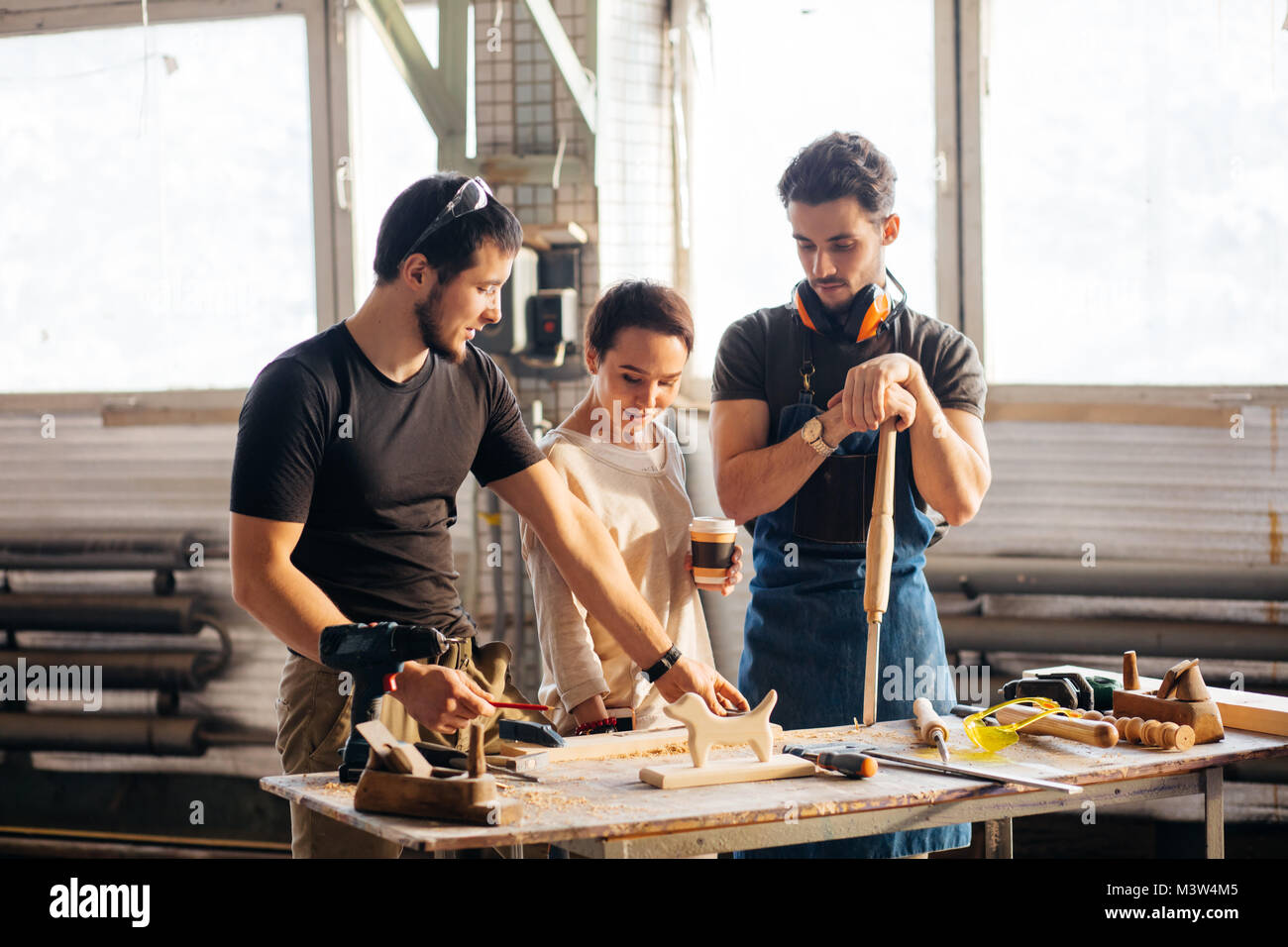 Carpenter Training Female Apprentice To Use Plane Stock Photo - Alamy