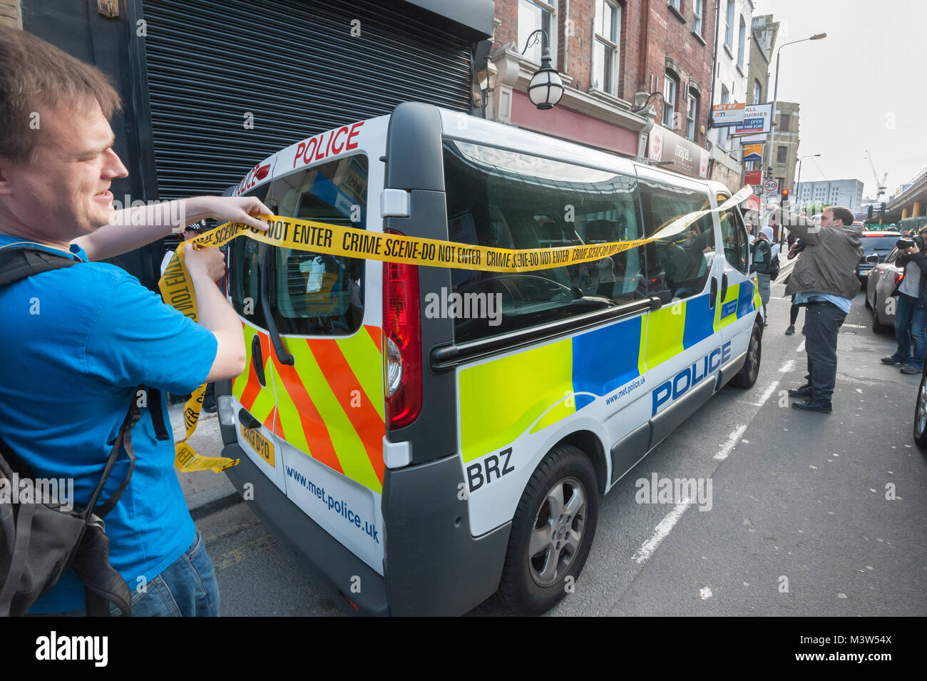 Class War protesters at the protest drape yellow tape with the message ...