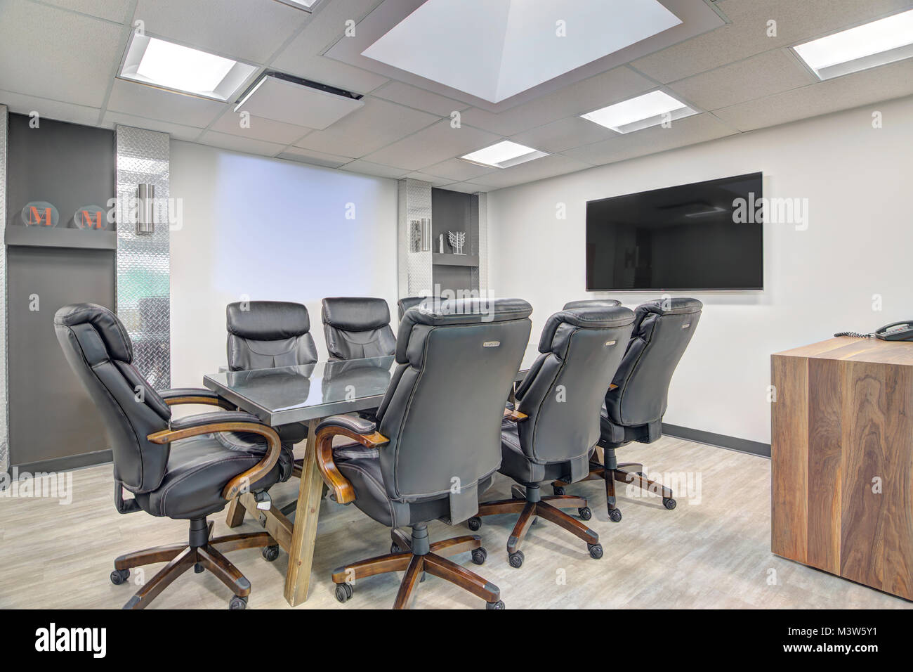 A small, eight-person corporate meeting room for company presentations ...