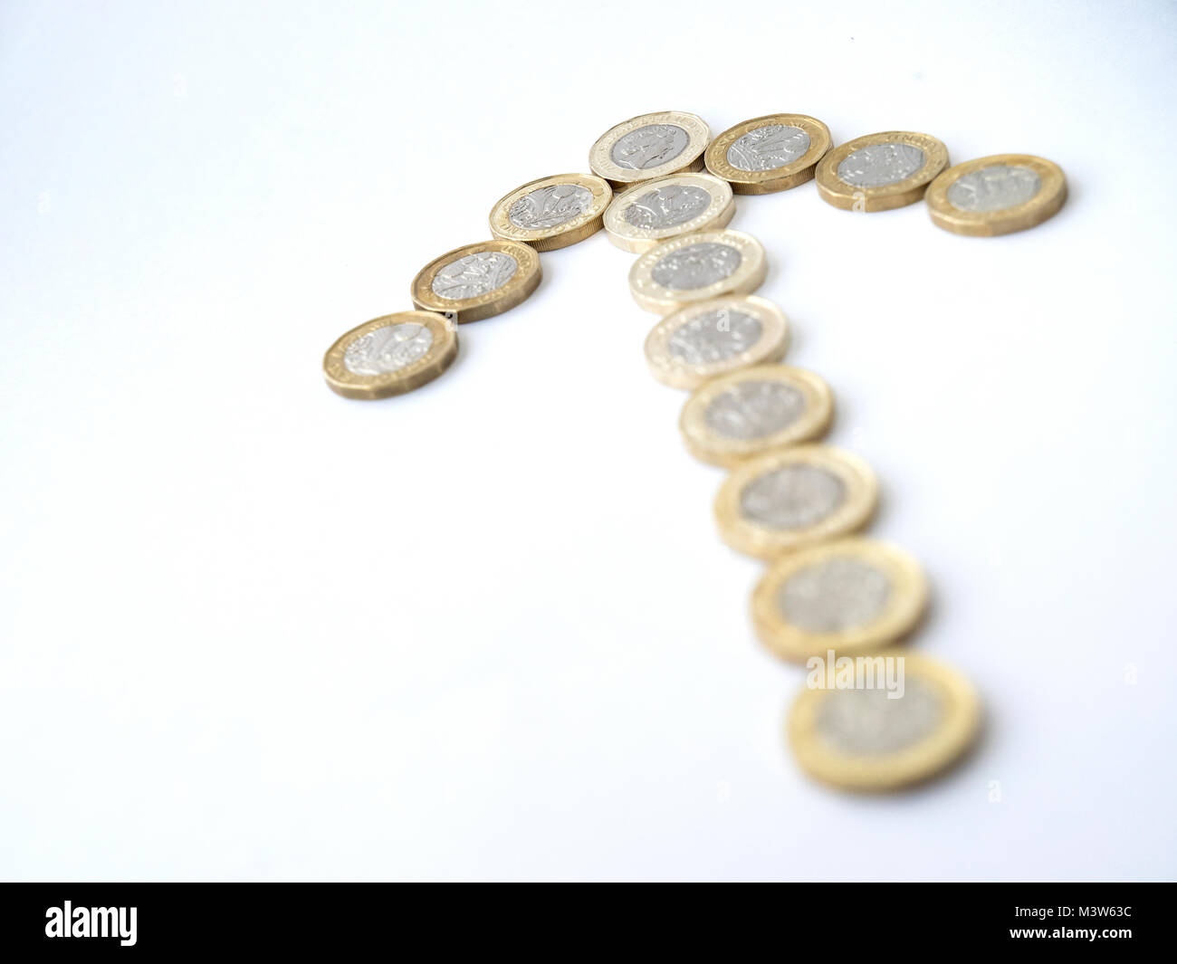 Several british pound coins arranged in the shape of an arrow Stock ...