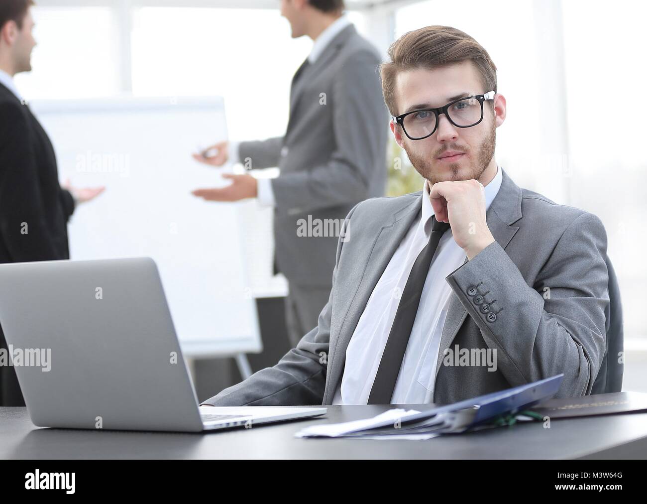 successful businessman sitting at Desk in office Stock Photo - Alamy