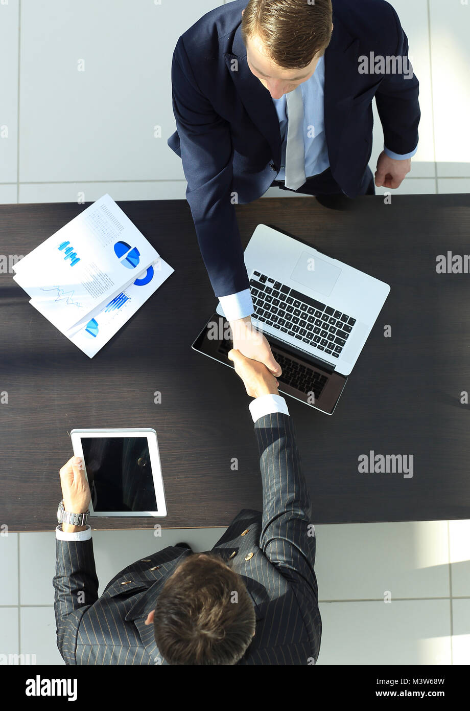 handshake of business partners above the Desk Stock Photo - Alamy