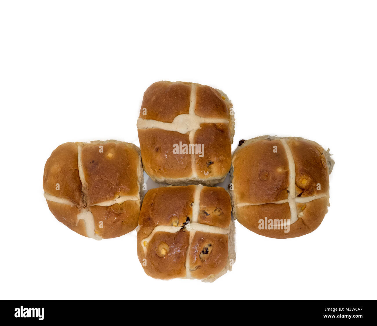 Four freshly baked hotcross buns in the shape of a cross and laid ...