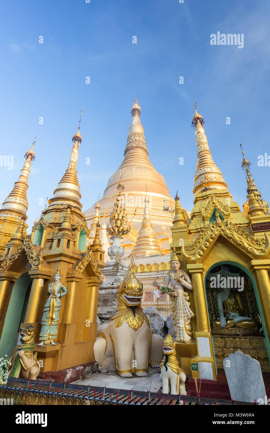 Small pagodas and statues in front of the gilded Shwedagon Pagoda in ...