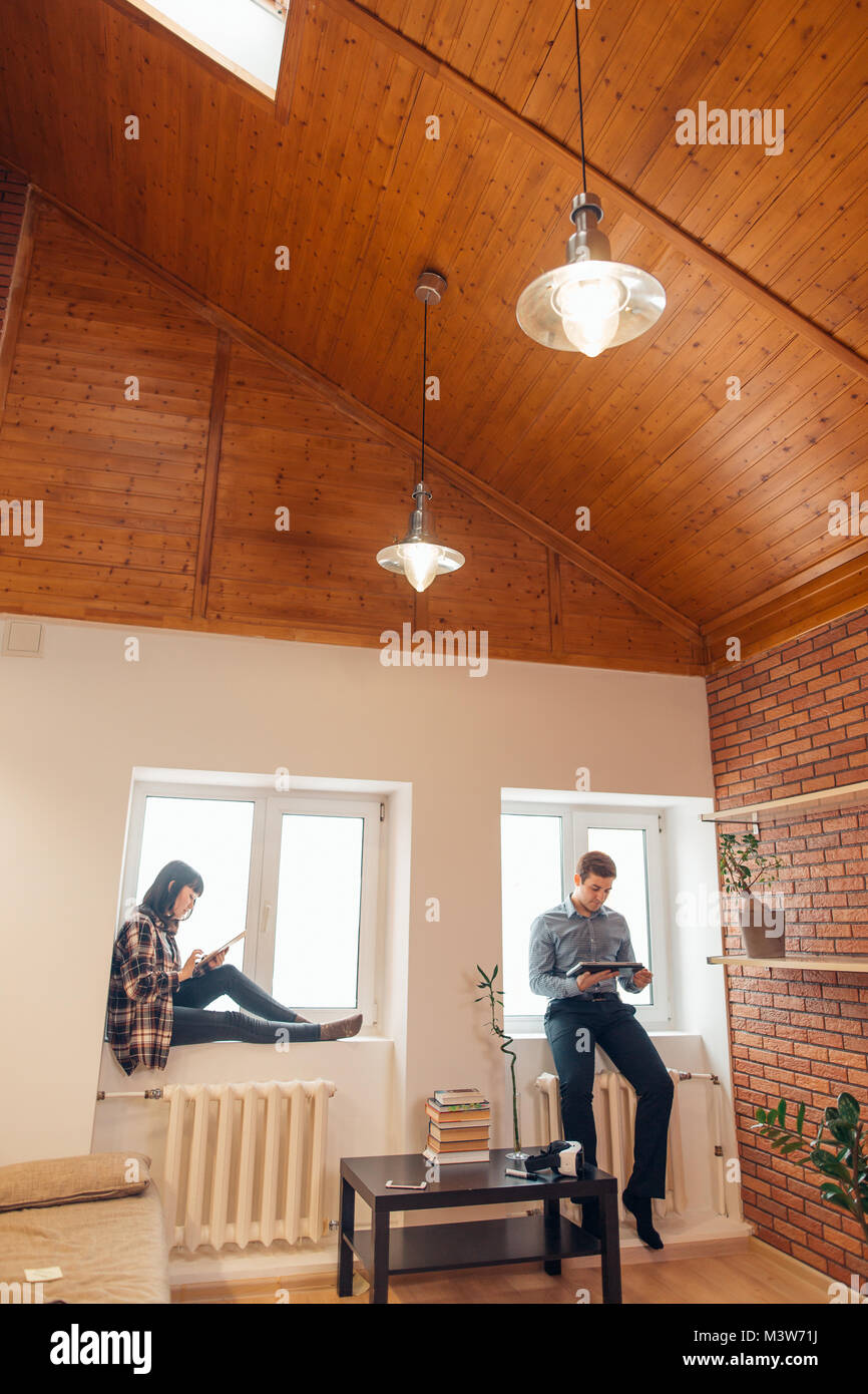 man and woman sitting back to back and doing their works Stock Photo ...
