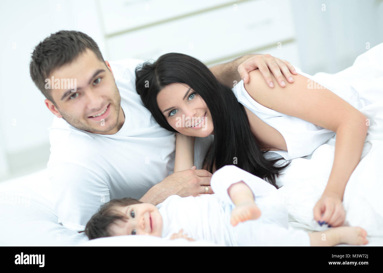 Happy young family with one child having fun together Stock Photo - Alamy