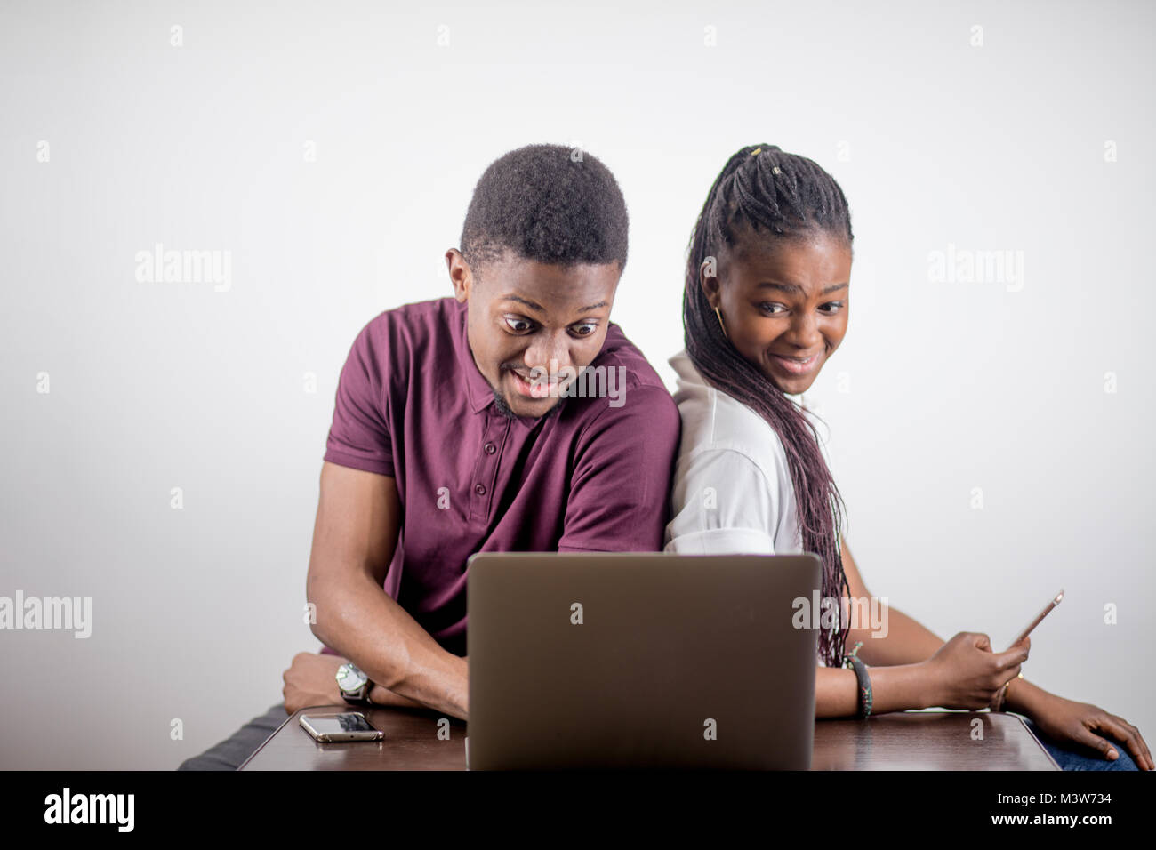 black girl sitting in front of laptop s looking on screen Stock Photo ...
