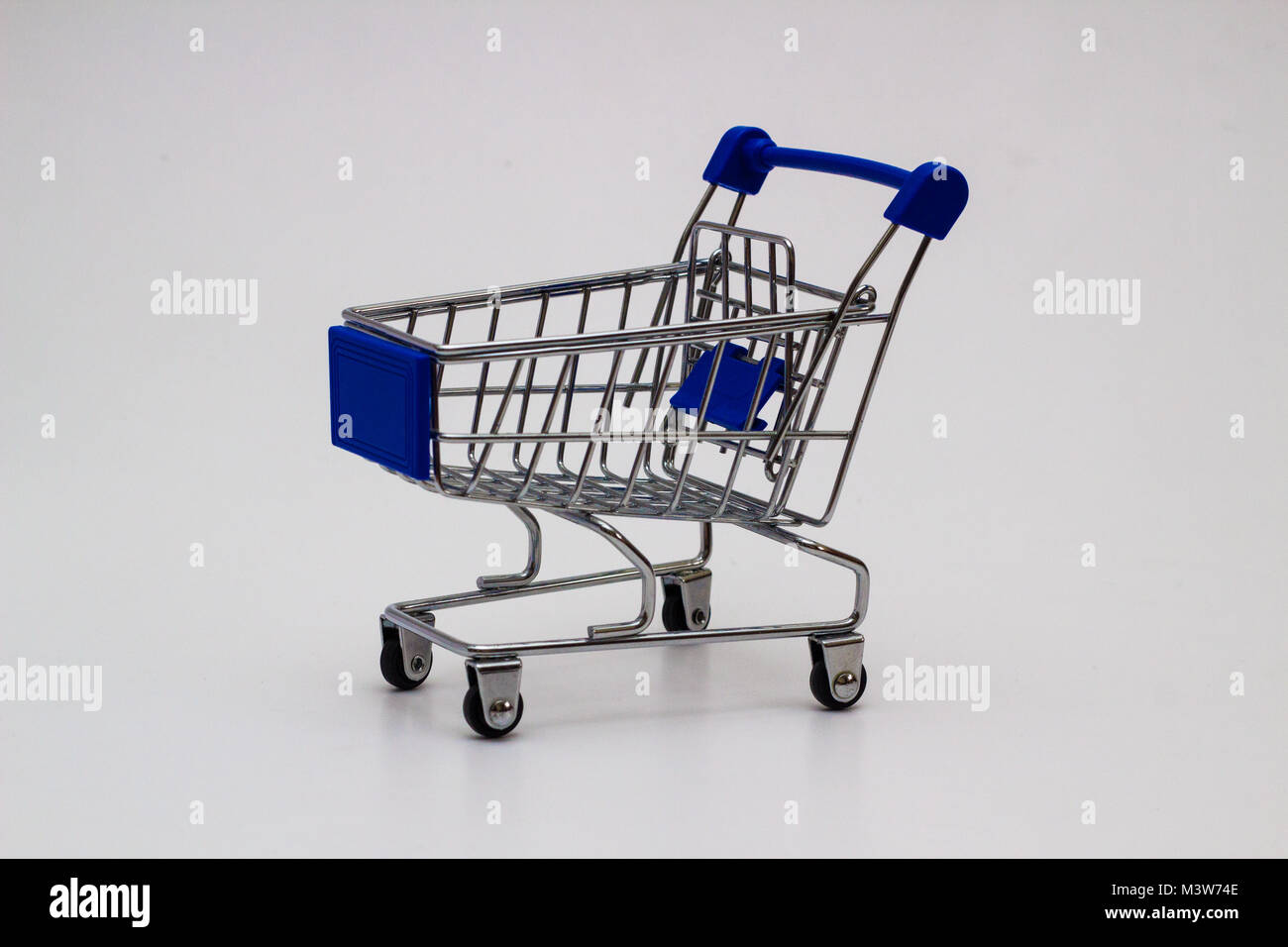 Small Shopping Cart on white background Stock Photo - Alamy