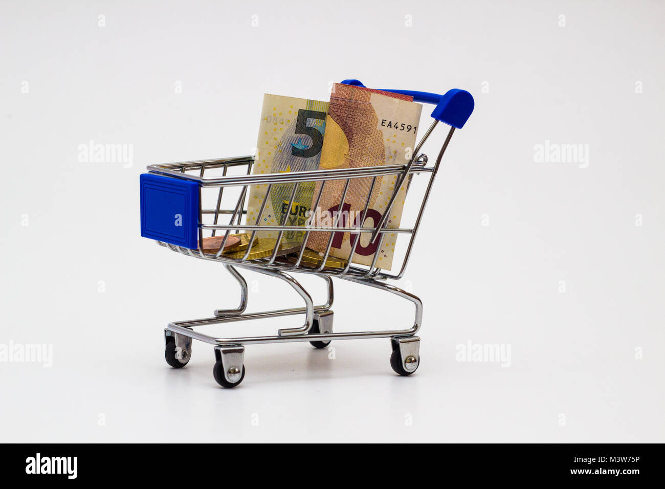 Shopping Cart with Euro banknotes and coins on it , against white ...
