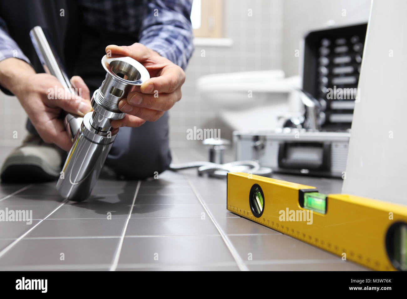 hands plumber at work in a bathroom, plumbing repair service, assemble ...