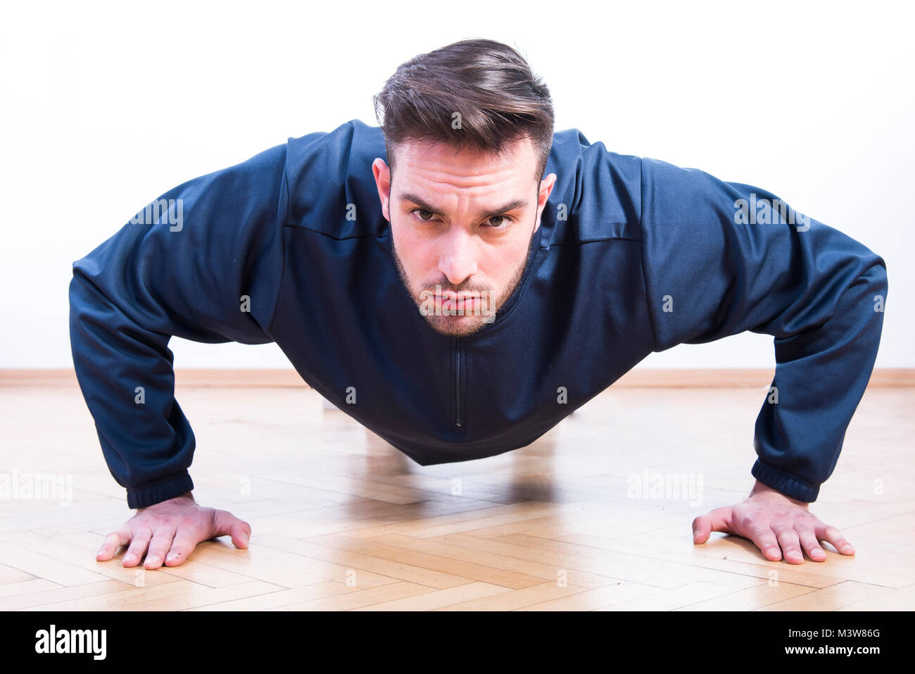 Fitness man doing push ups on a floor Stock Photo - Alamy
