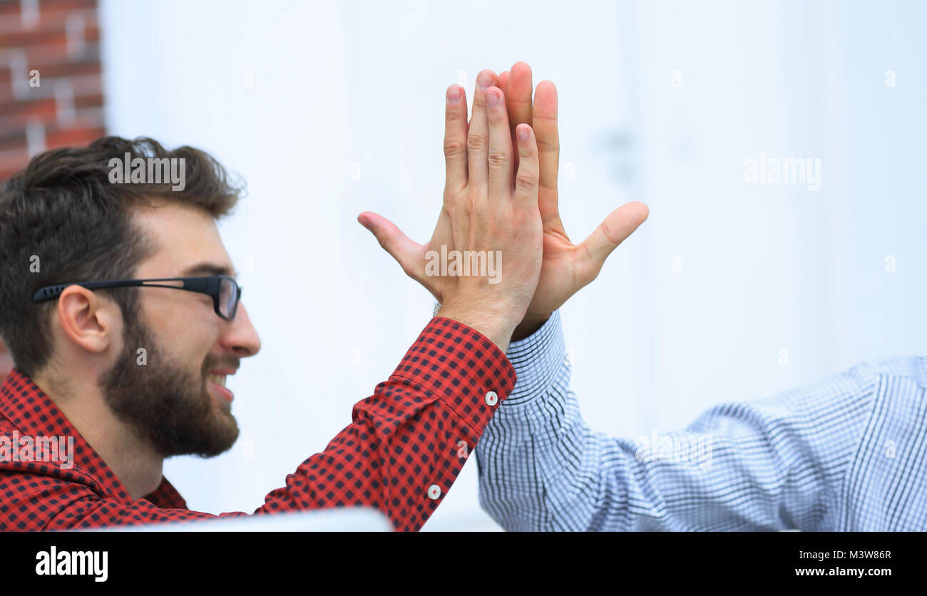 closeup.colleagues giving each other high five Stock Photo - Alamy