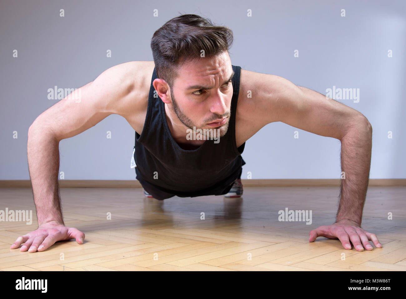 Fitness man doing push ups on a floor Stock Photo - Alamy