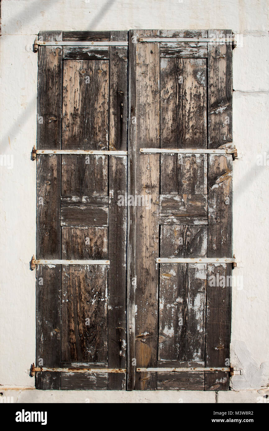 Old, rusty, typical, closed wooden window shutters in old town of Cunda ...