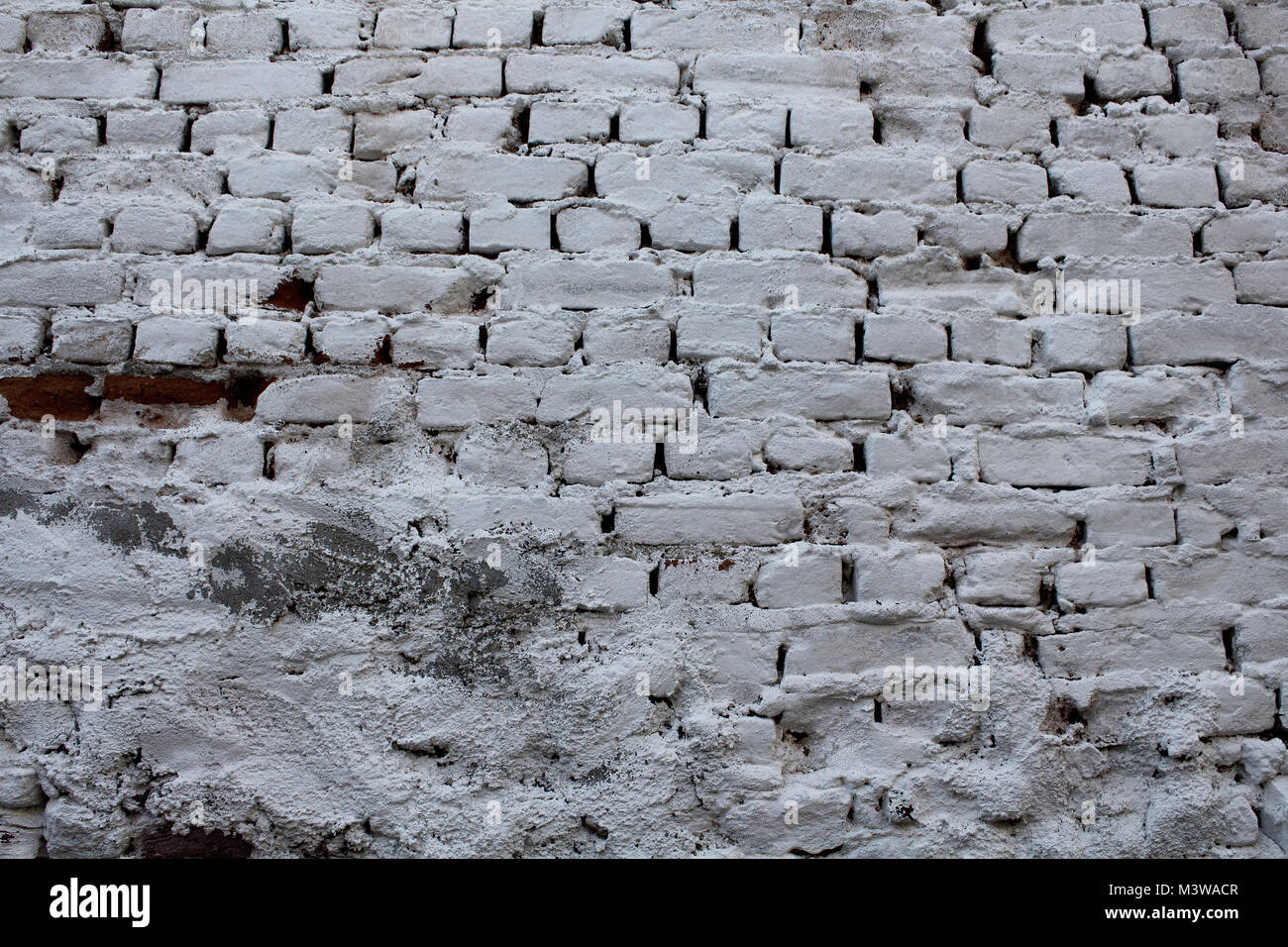 Close up view of brick wall background covered with white plaster Stock ...