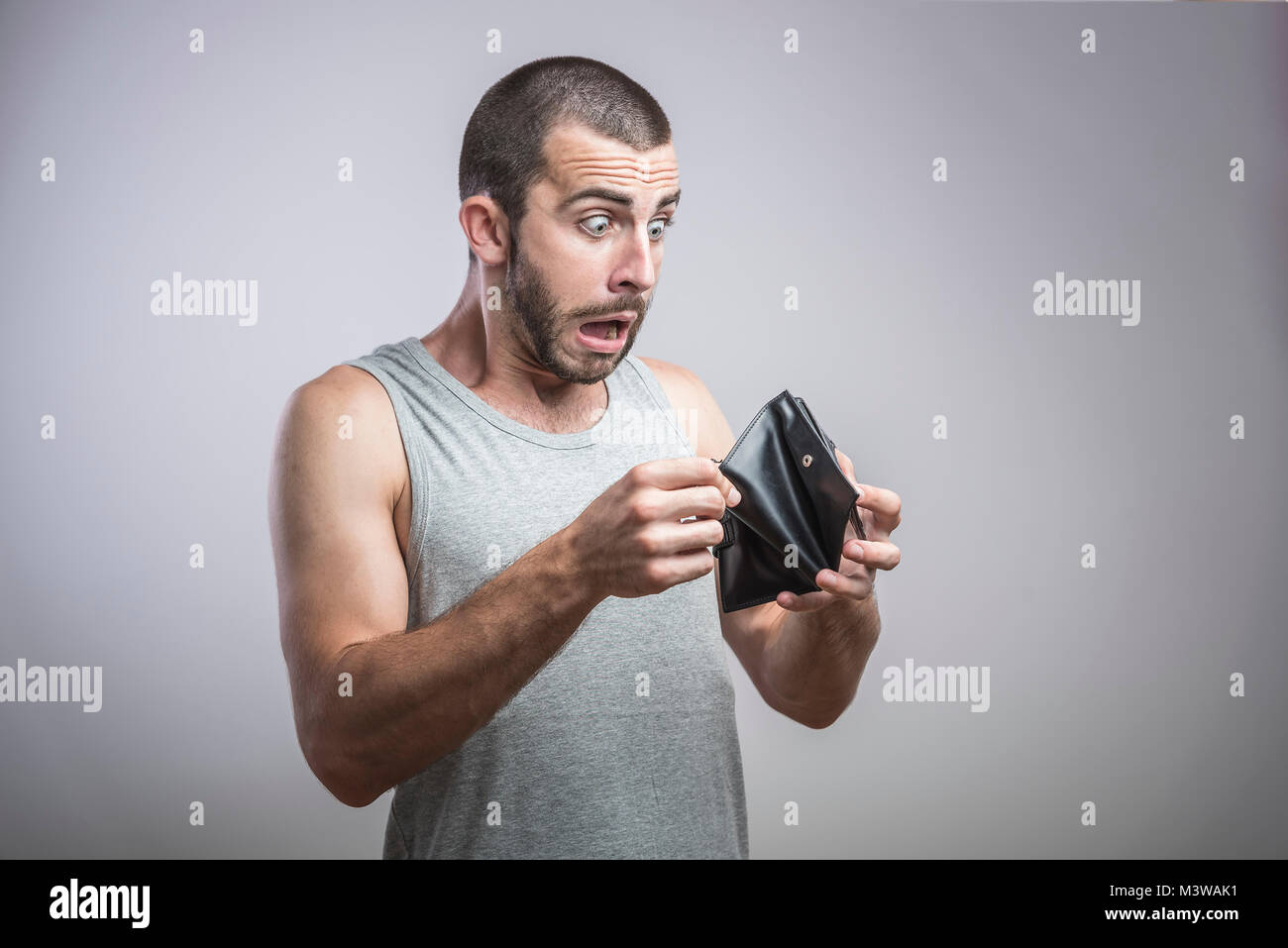 Shocking man with an empty wallet Stock Photo - Alamy