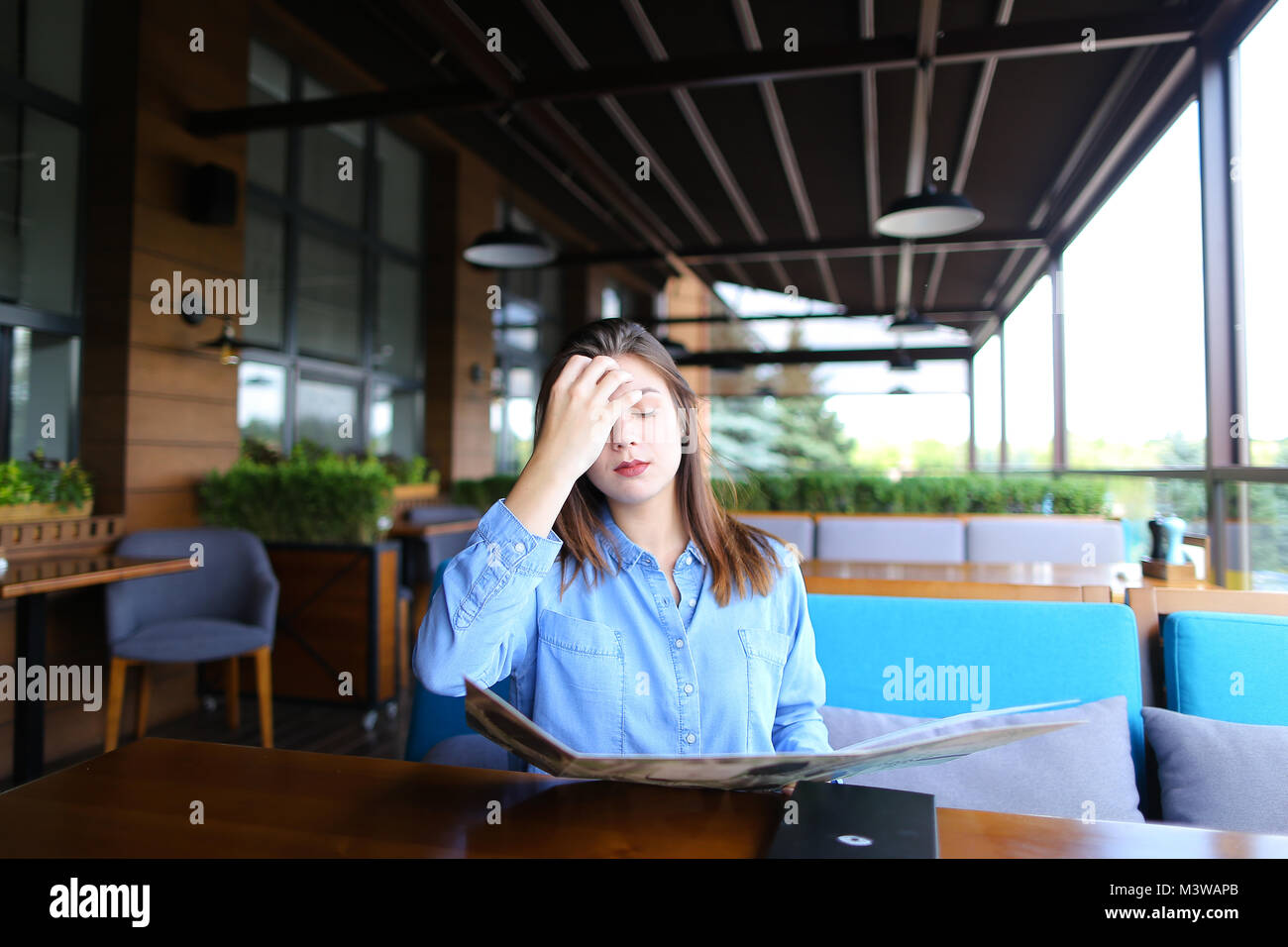 Beautiful lady reading menu at cafe Stock Photo - Alamy