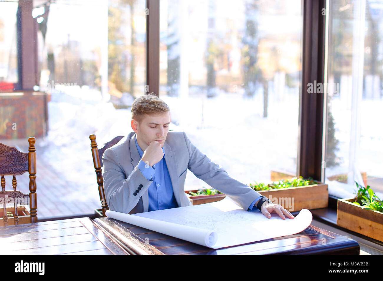 Student of architecture faculty looking at drafting work at cafe Stock ...