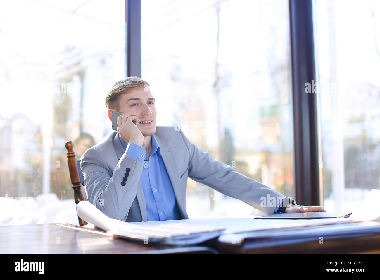 Architect calling customer by smartphone and asking about projec Stock ...