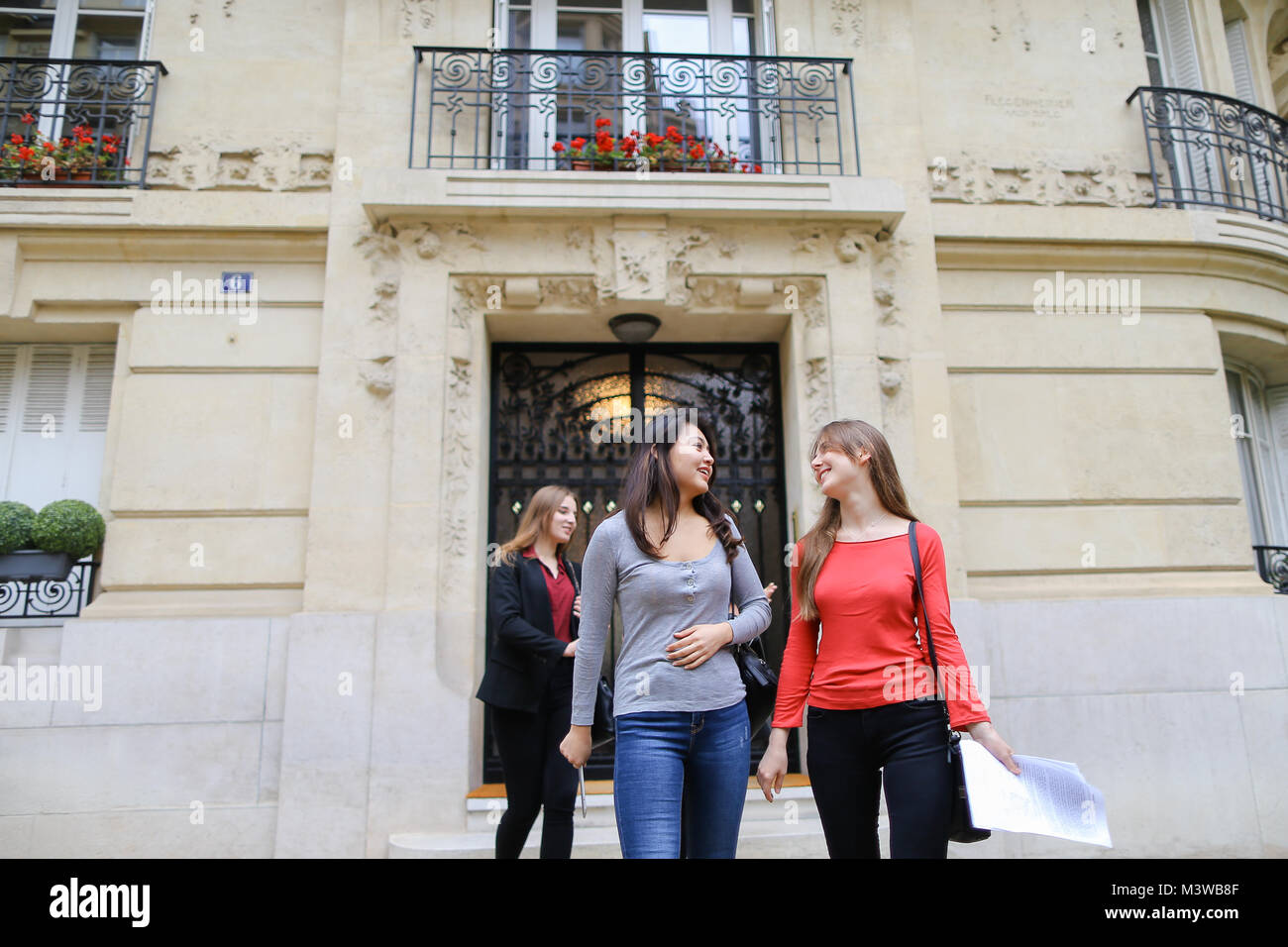 Happy students leaving university building in Stock Photo - Alamy