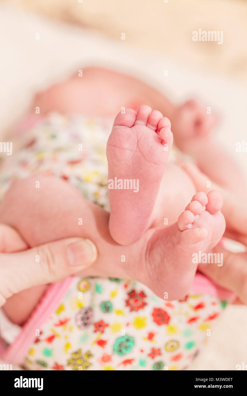 Small tender baby legs of newborn baby's feet Stock Photo - Alamy
