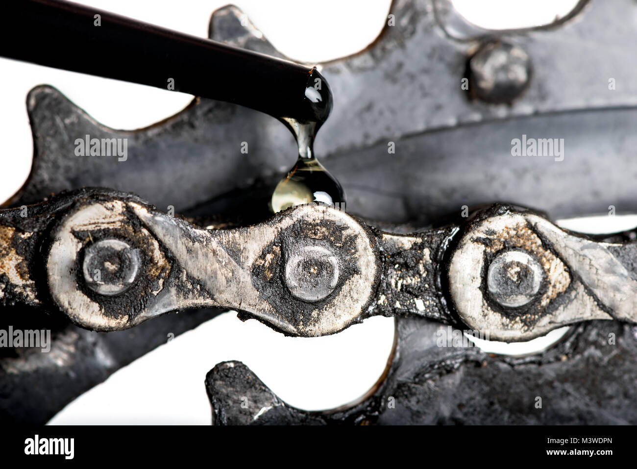 a drop of oil on a chain of a bicycle photo of a close-up isolated on ...