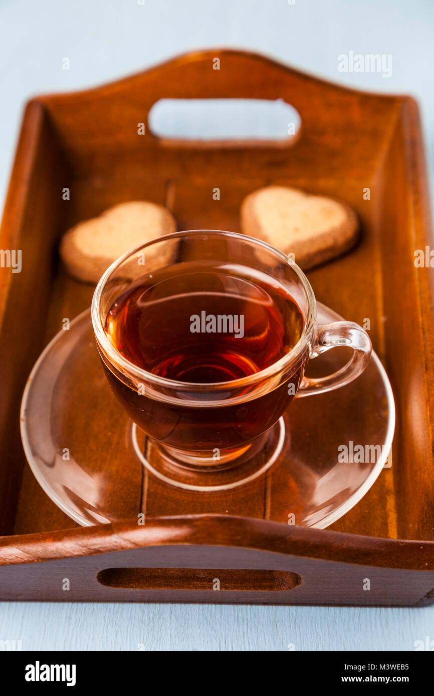 Heart-shaped biscuits and tea on a wooden tray for St. Valentine's Day ...