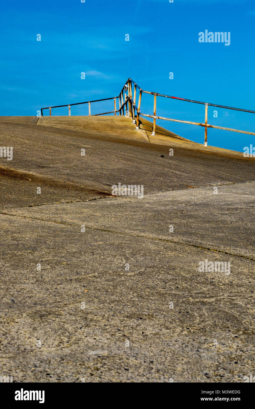 A concrete slipway and fence Stock Photo - Alamy