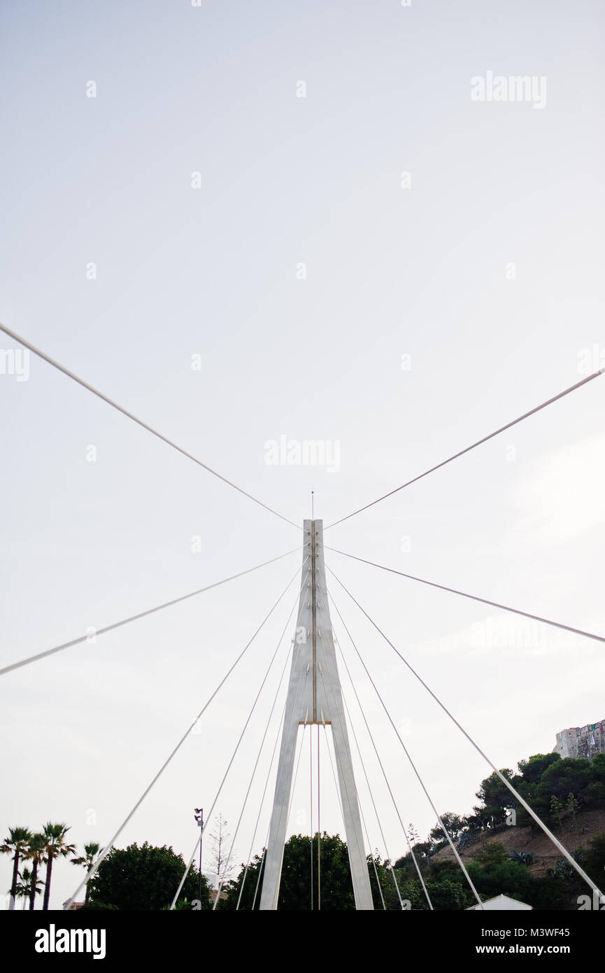 Tall white bridge in a city. Close-up photo of its ropes Stock Photo ...