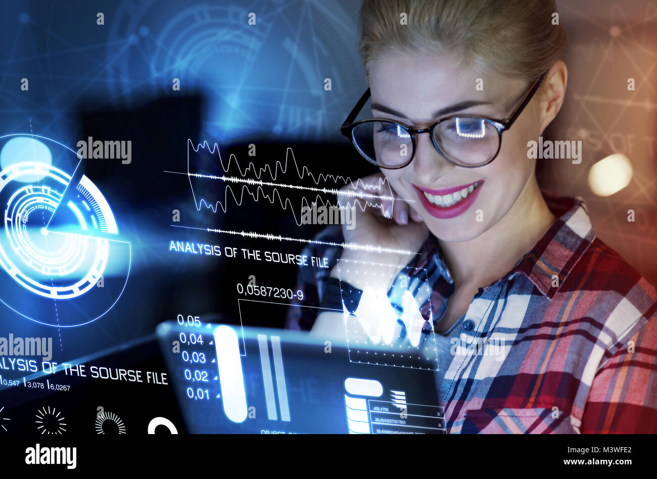 Emotional programmer smiling and looking at the screen Stock Photo - Alamy