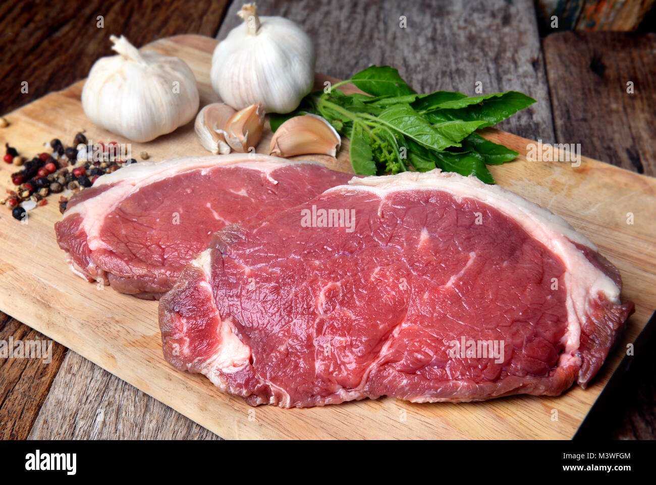 Rare Angus beef cut and ready for cooking display with seasoning and ...