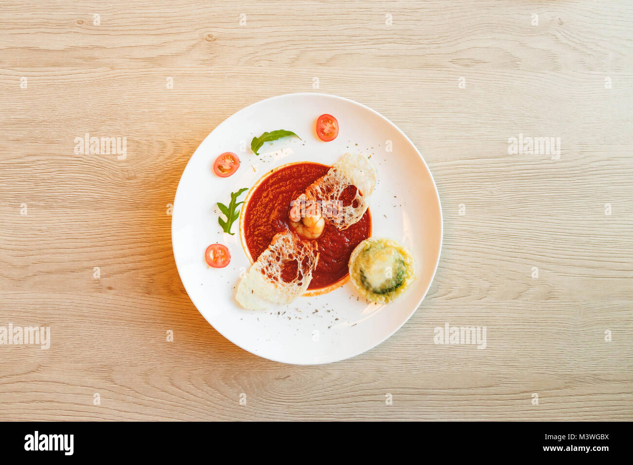 tomato soup on kitchen table. top shot Stock Photo - Alamy