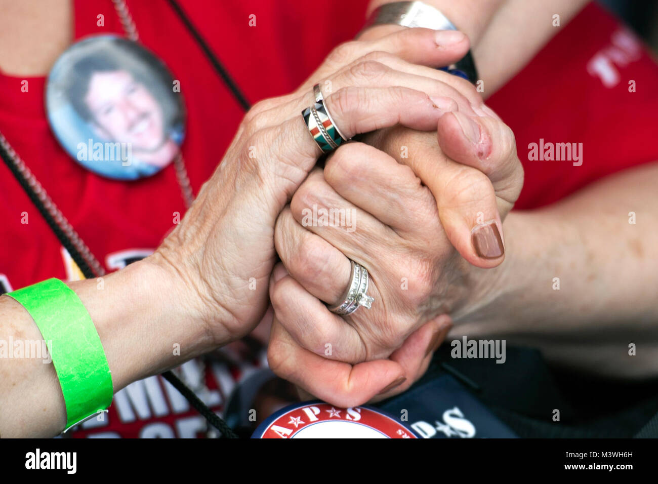 Tragedy Assistance Program for Survivors members hold hands during the ...