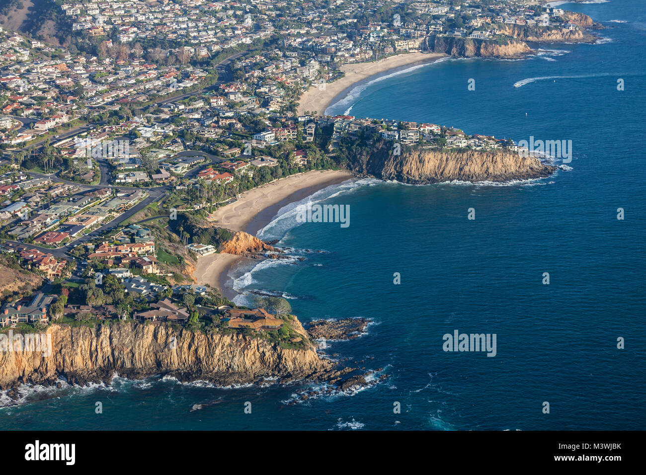 Aerial view of affluent homes surrounding scenic coves in Laguna Beach ...