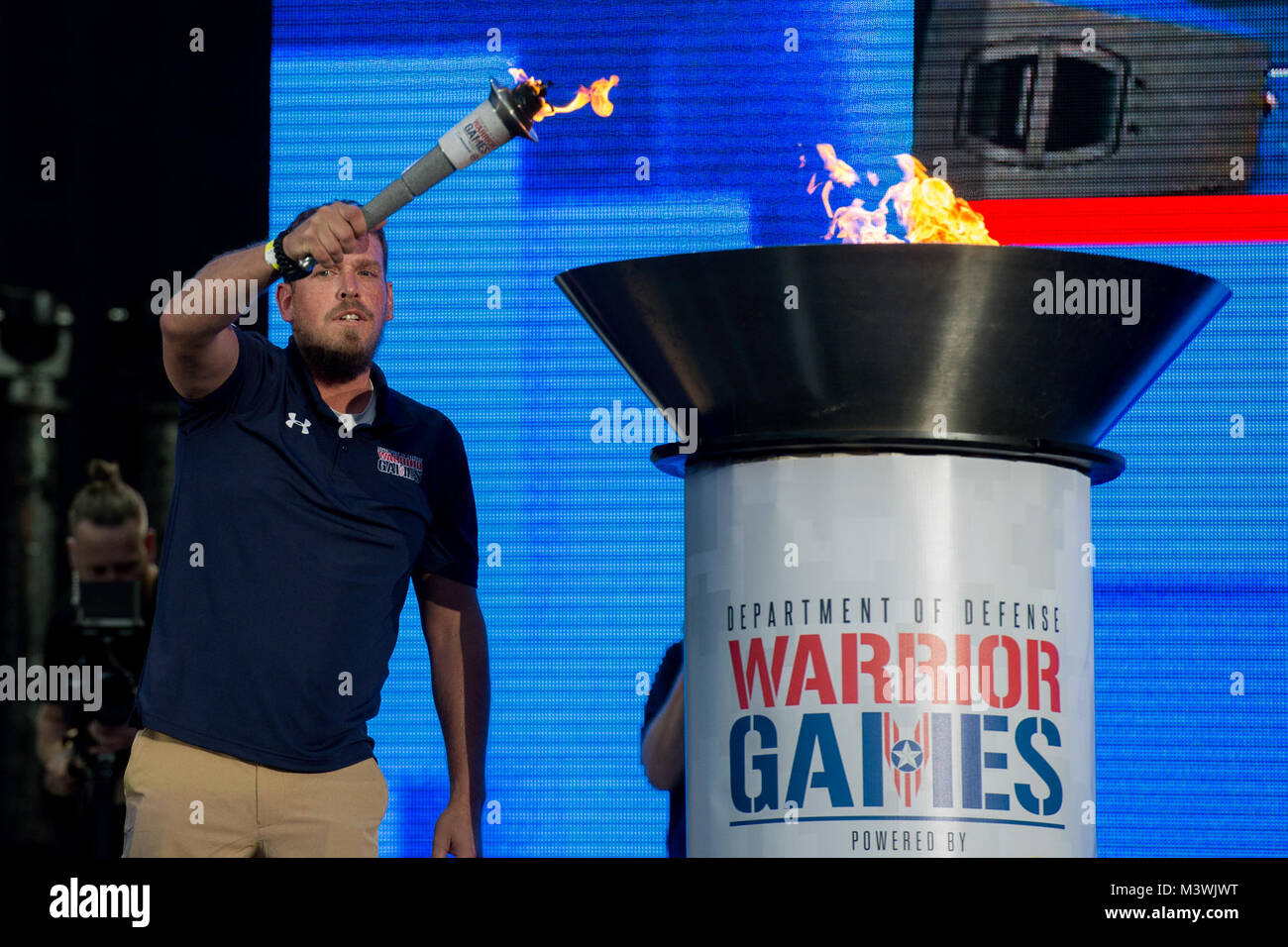 Retired Navy Petty Officer 3rd Class Nate Hamilton lights the 2017 ...