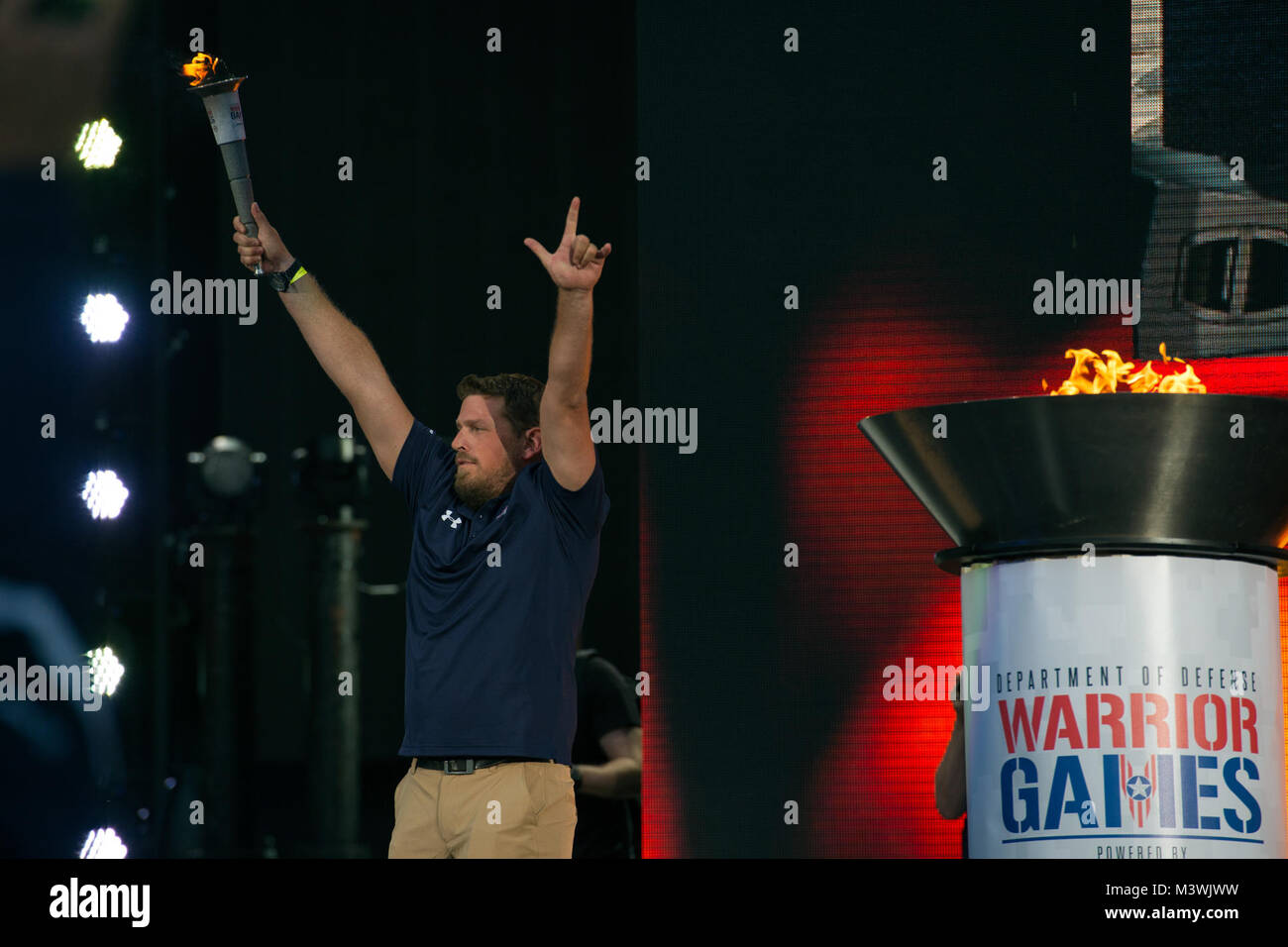 Retired Navy Petty Officer 3rd Class Nate Hamilton reacts to lighting ...
