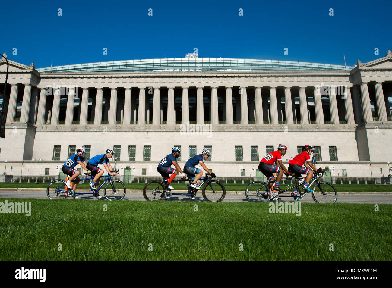 Visually impaired riders race with their guiding drivers in front of ...