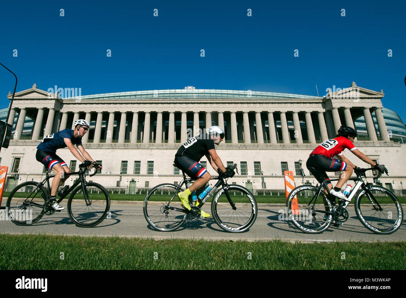 Bicyclists race in front of the Soldier Field facade along Museum ...