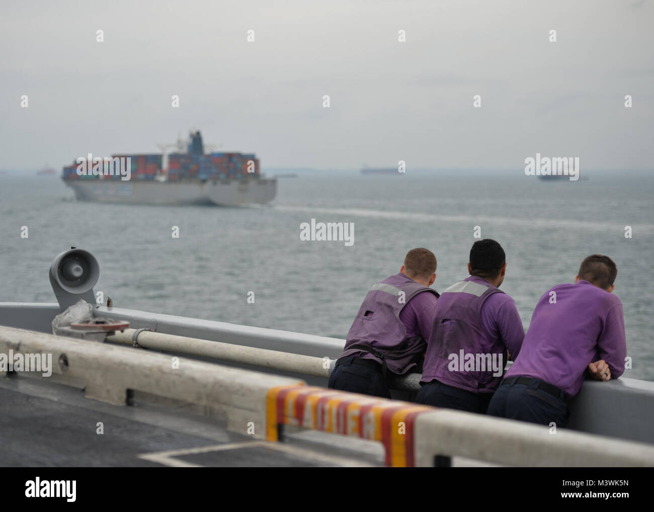 SINGAPORE STRAIT (July 6, 2017) U.S. Navy Sailors observe passing ships ...