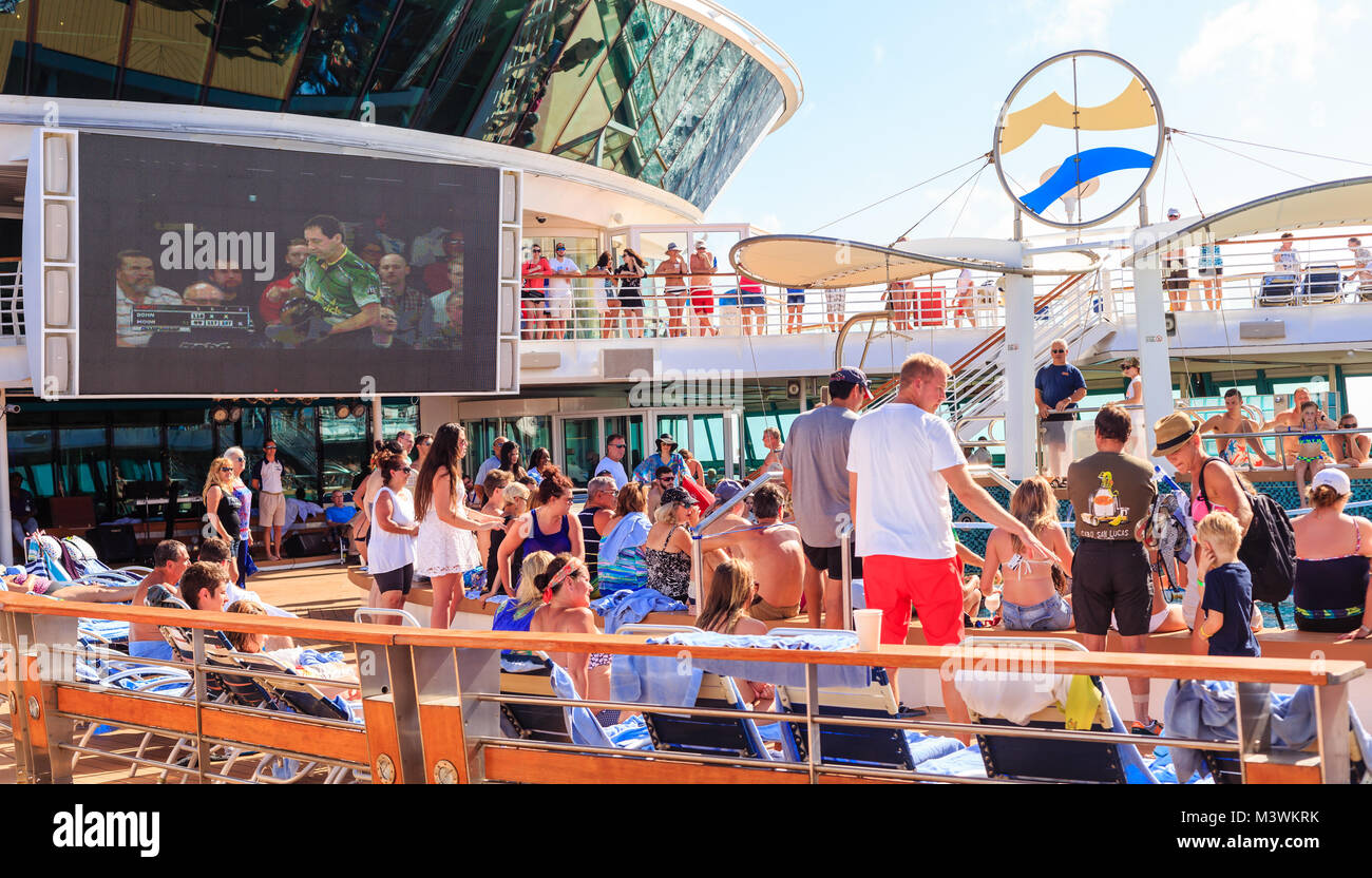 Passengers on the deck of a luxury cruise ship having fun around the ...