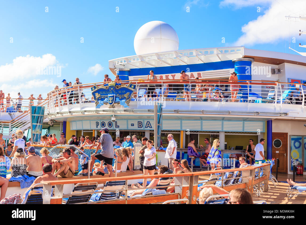 Passengers on the deck of a luxury cruise ship having fun around the ...