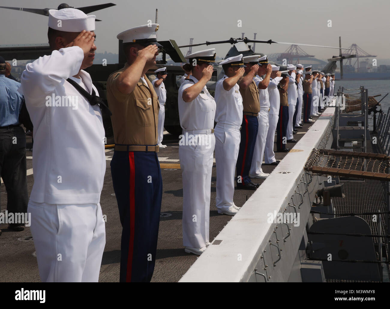 Marine and Sailors man the rail aboard the USS Anchorage during the ...