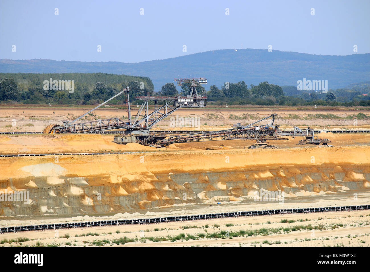 Giant excavator digging coal on open pit coal mine Stock Photo - Alamy