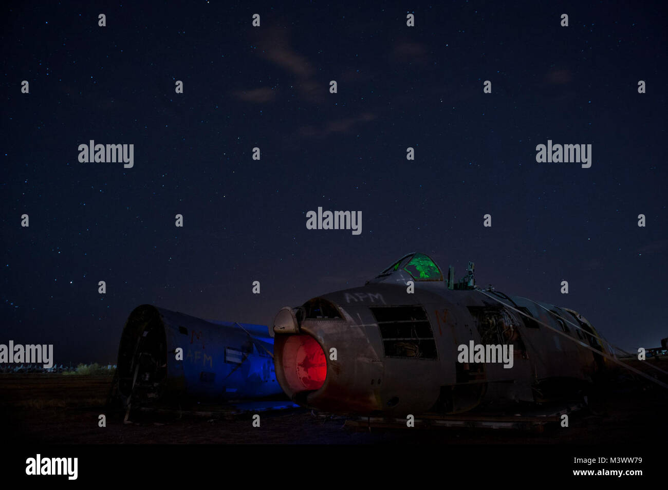 A North American F-86 Sabre sits in pieces under the night sky at the ...