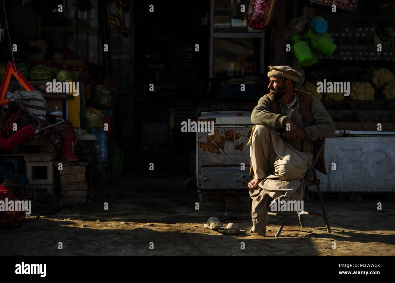 A local Afghan watches as 455th ESFS Airmen walk through the village ...