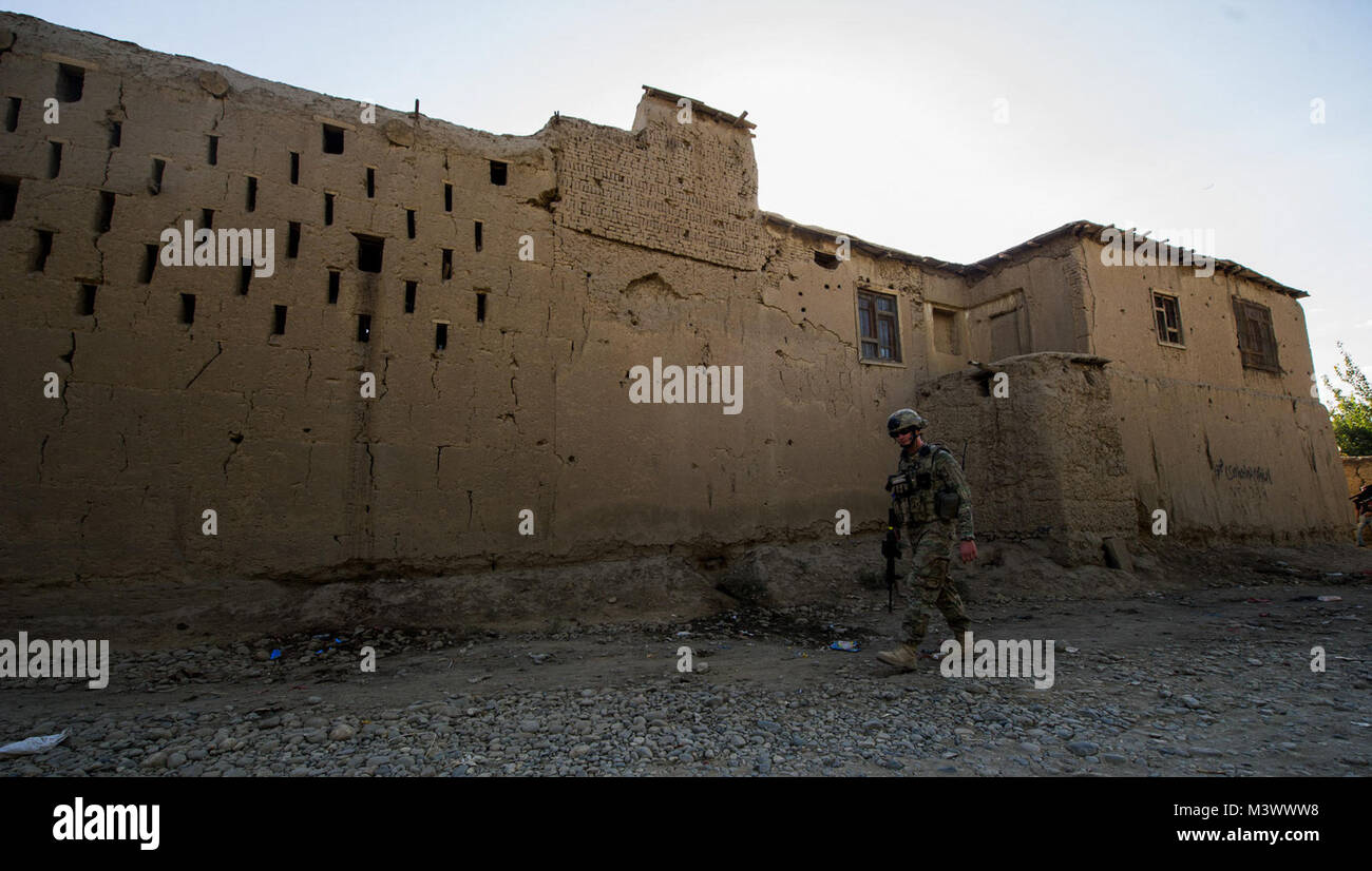 Staff Sgt. Eric Doolittle makes his way through a village outside ...