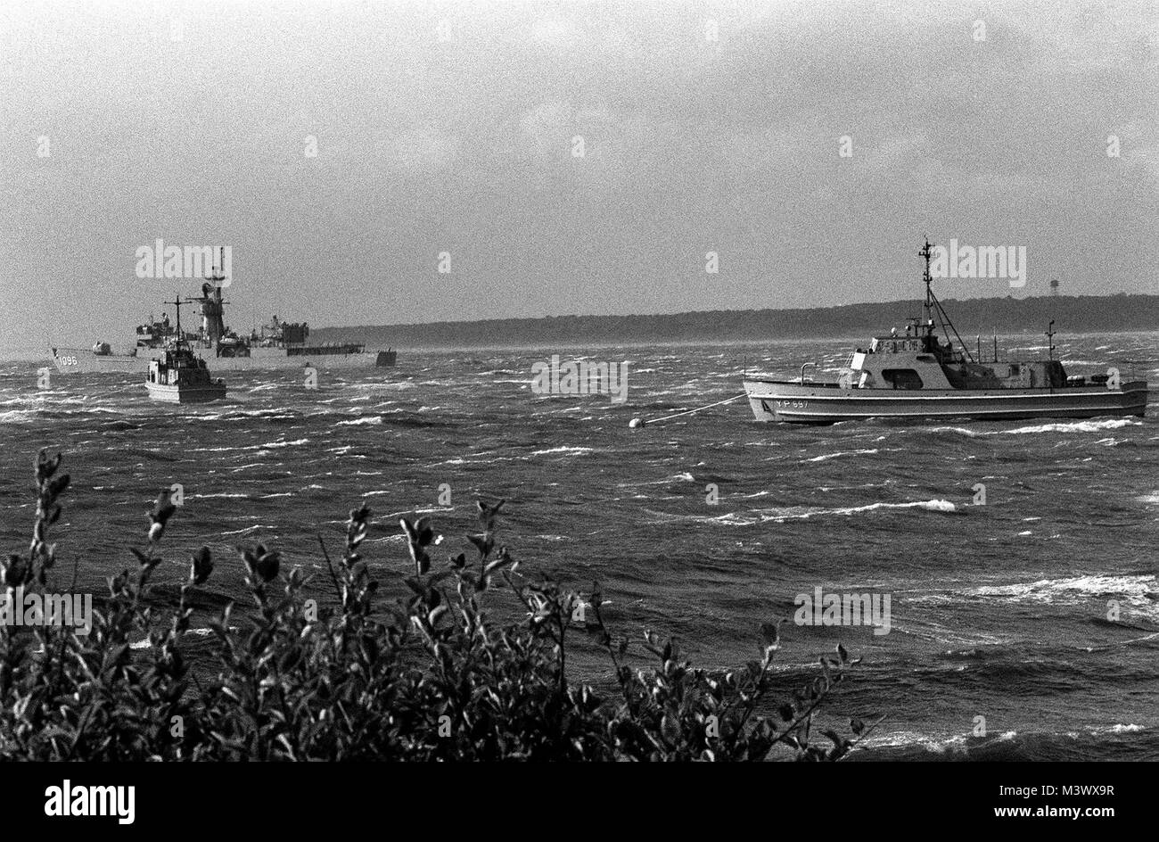 Two yard patrol craft and the frigate USS VALDEZ (FF-1096) ride out the ...
